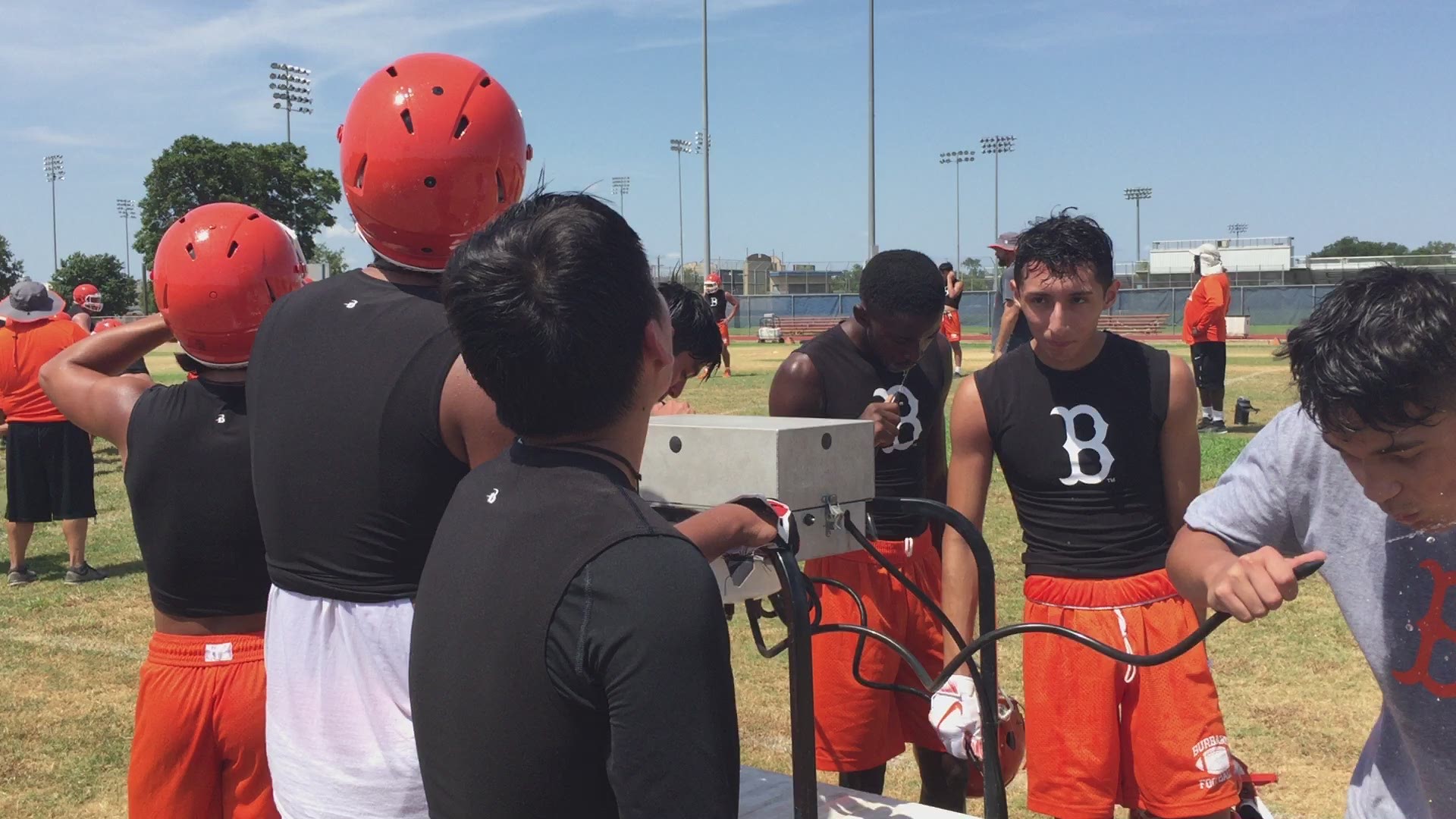 High school players focus on staying hydrated as football workouts ...