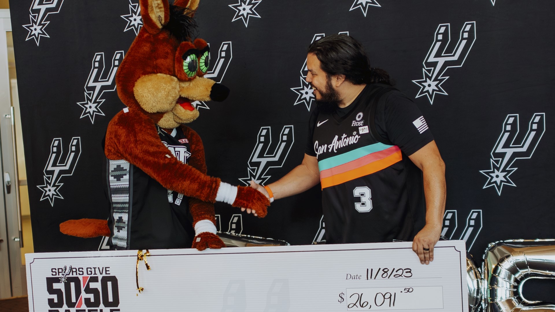 Spurs Give presents San Antonian with the largest check from | kens5.com