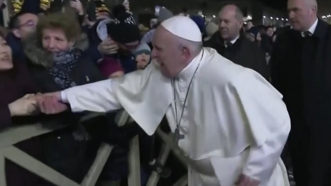 Pope Francis scolds woman and slaps her arm after she grabbed him ...